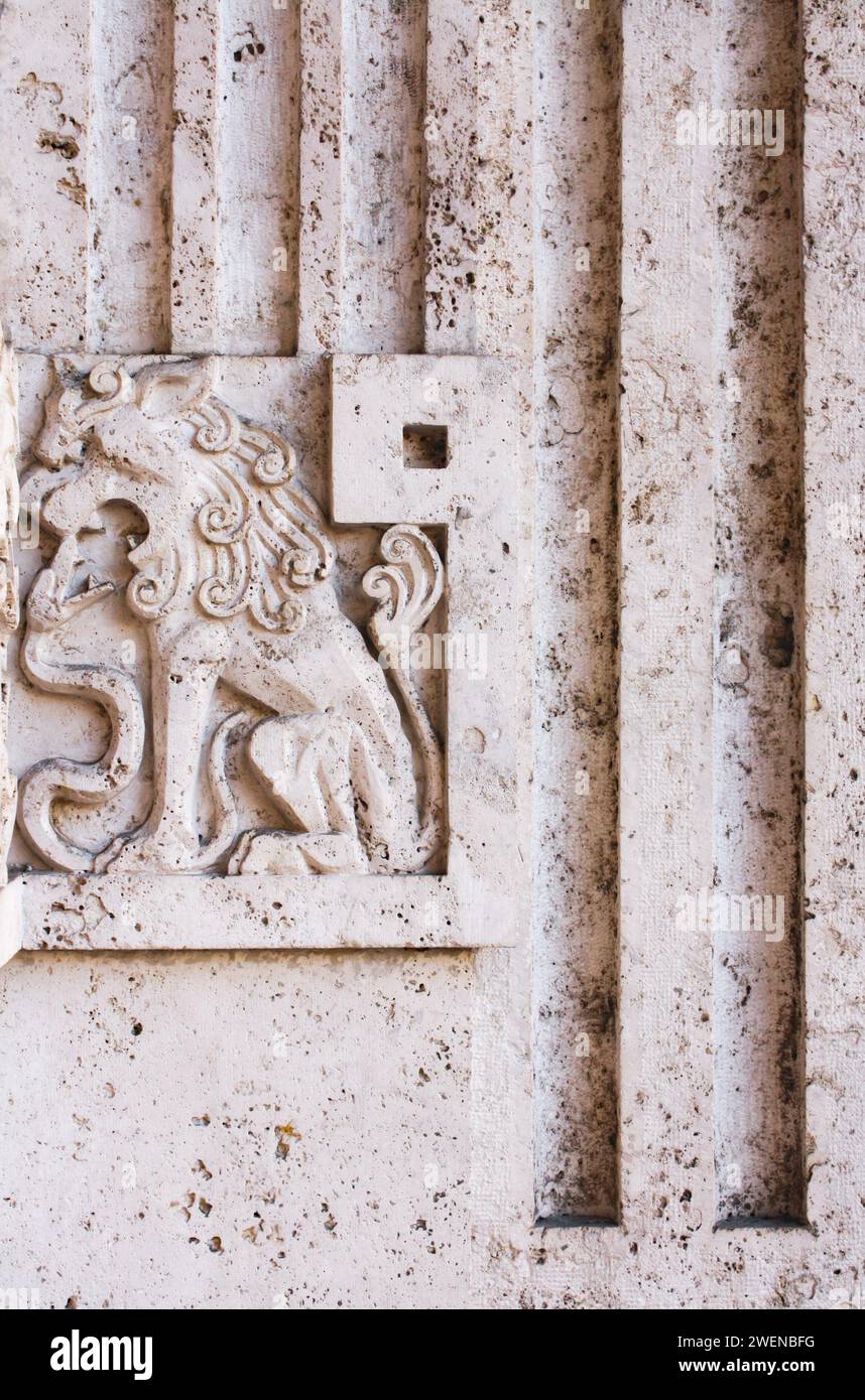 Detailed stone bas-relief of a lion and snake interaction, an ...