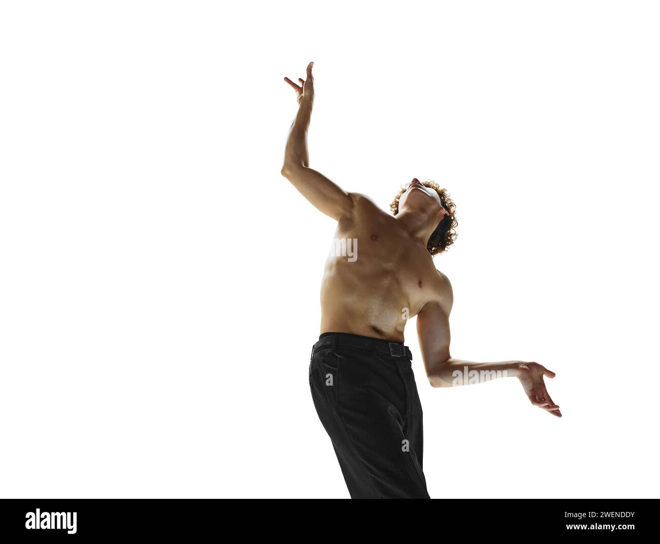 Dynamic shot shirtless male dancer with raised arms in expressive pose ...