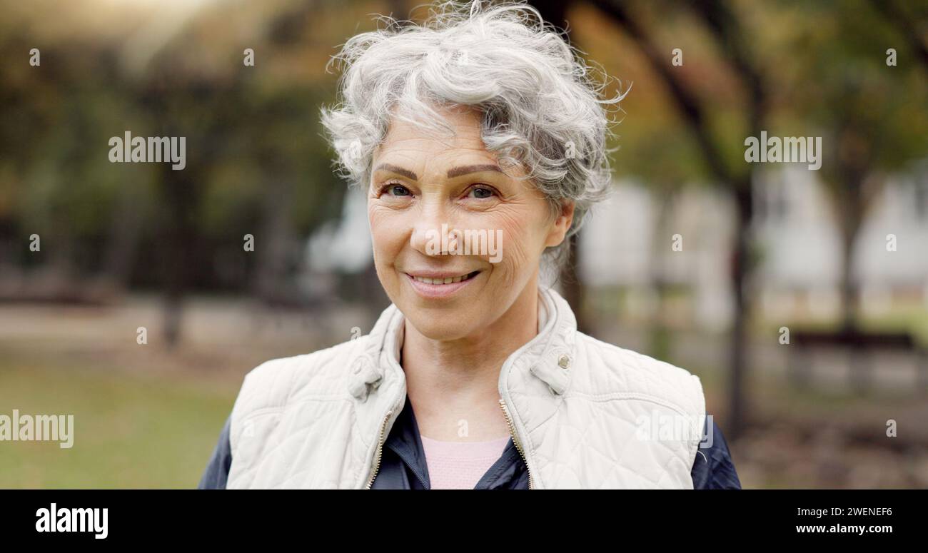 Portrait, senior woman and smile in the park with happiness in nature ...