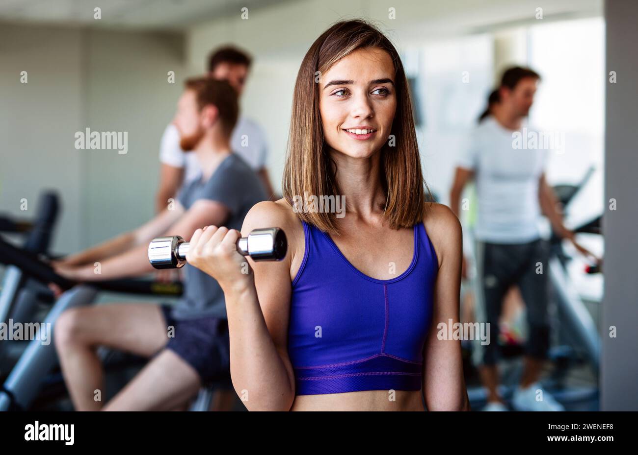 Fitness woman. Fit fitness girl smiling happy lifting weights looking ...