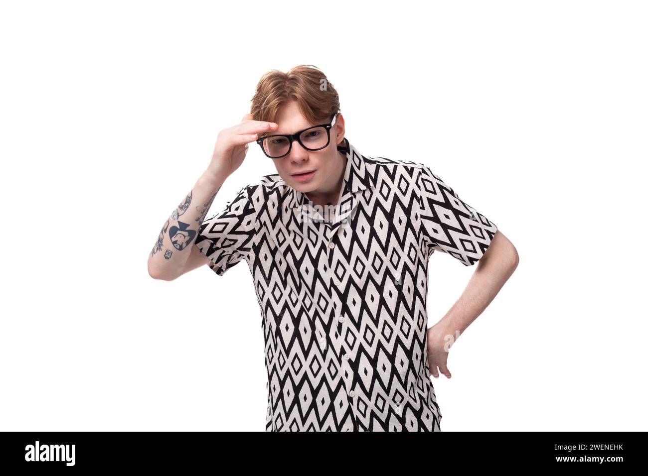 young upset angry caucasian ginger man with a tattoo on his arms is ...