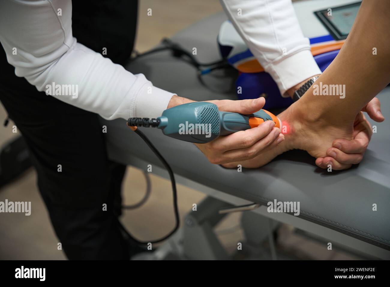 Doctor performing treatment with ultrasound machine in hospital Stock ...