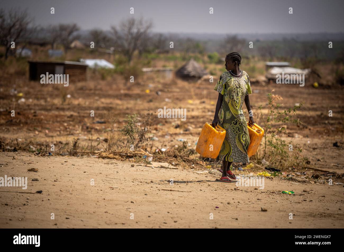 Juba, South Sudan. 26th Jan, 2024. A woman walks along the road with ...
