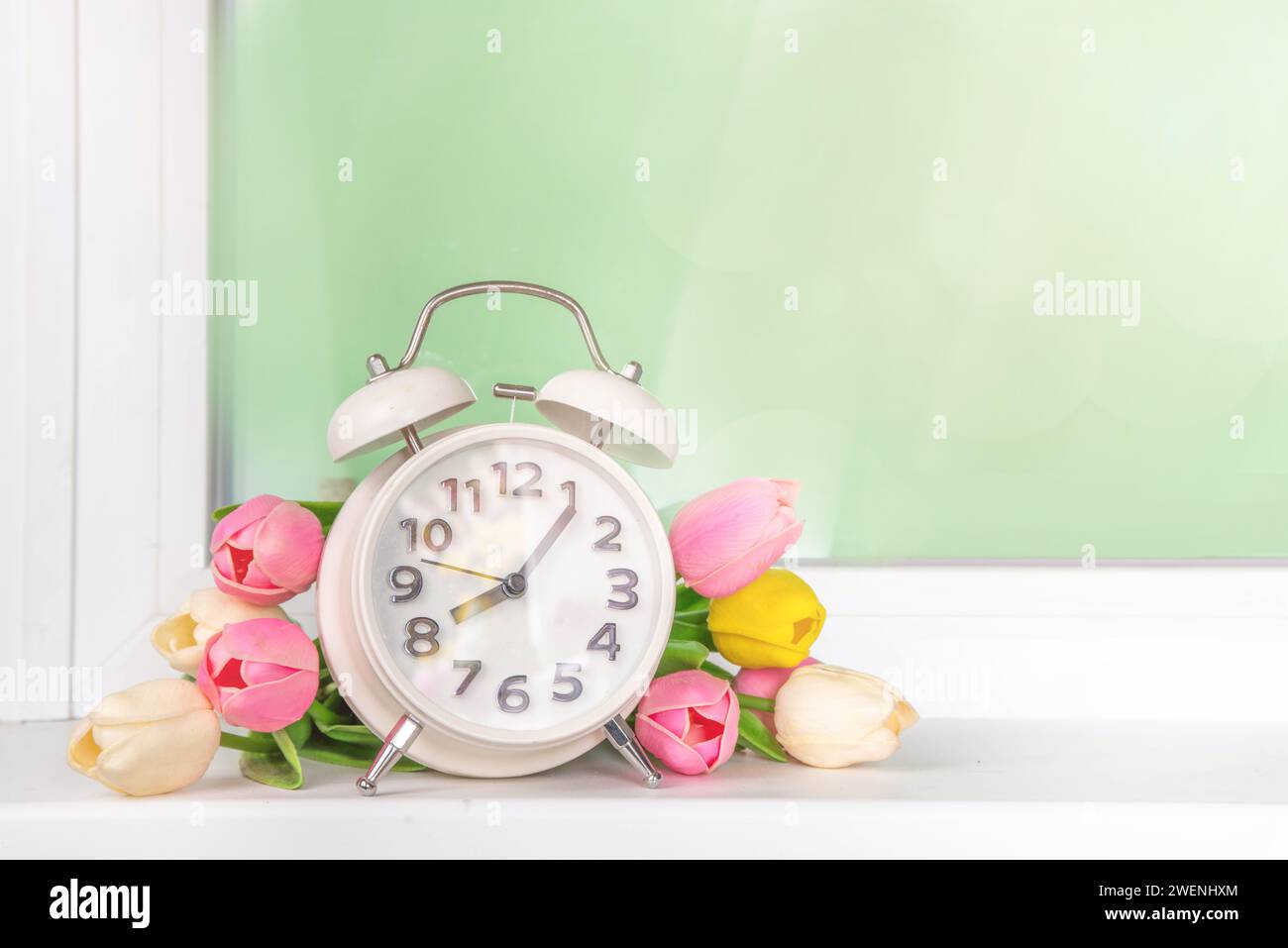 Spring Time Forward background with Alarm clock with spring flowers on ...
