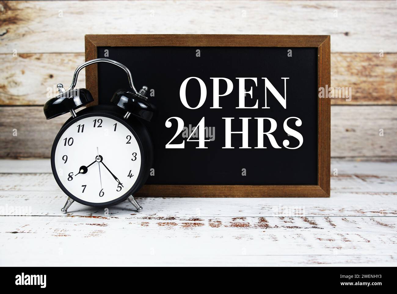 Open 24 HRS text message with alarm clock on wooden background Stock ...