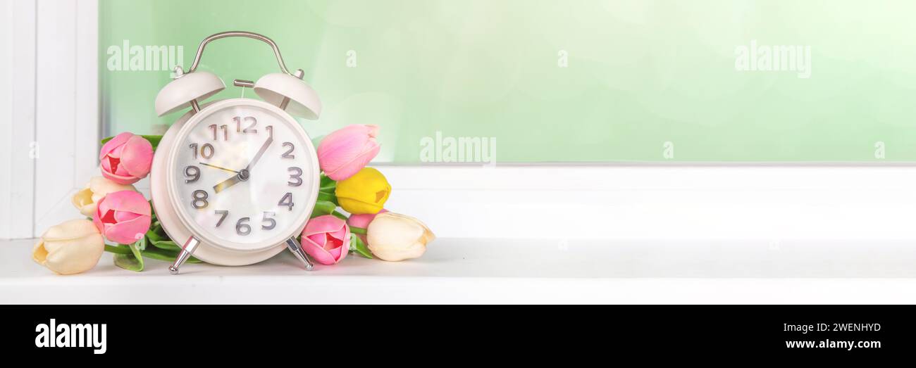 Spring Time Forward background with Alarm clock with spring flowers on ...