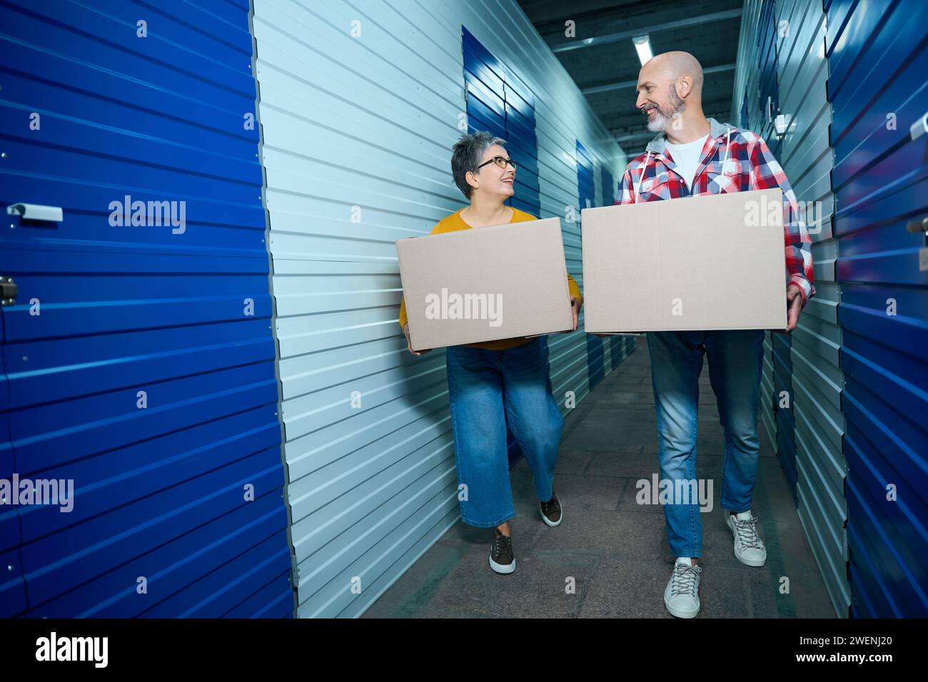 Two people carry cardboard boxes with things Stock Photo - Alamy