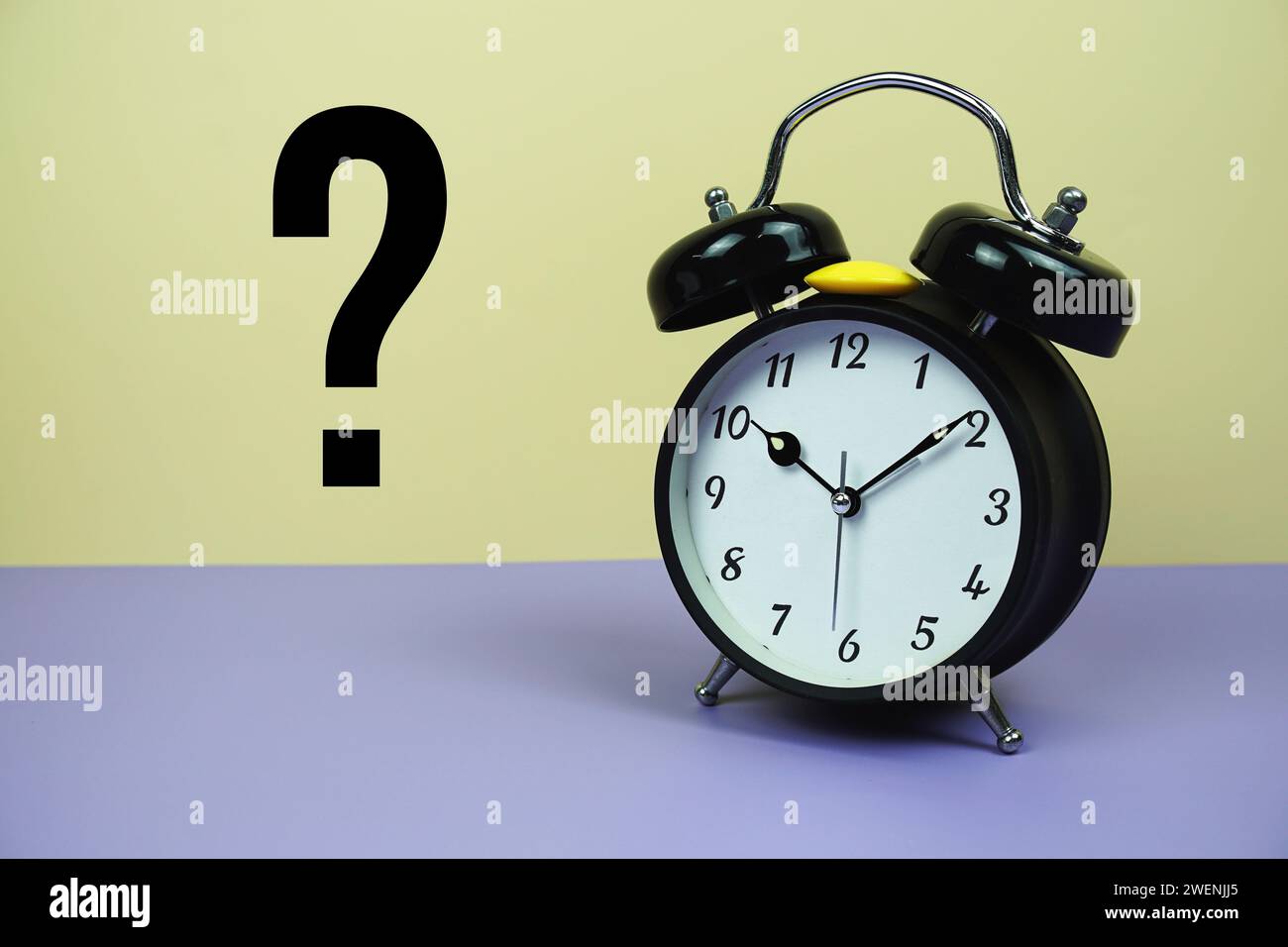 Question mark and alarm clock on yellow and purple background Stock ...