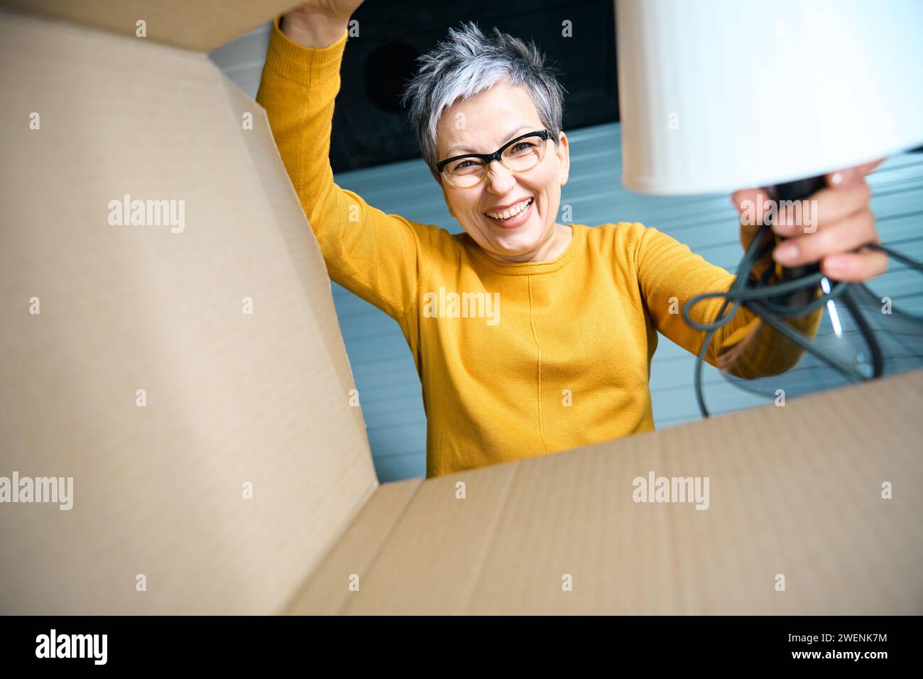 Smiling lady looks box hi-res stock photography and images - Alamy