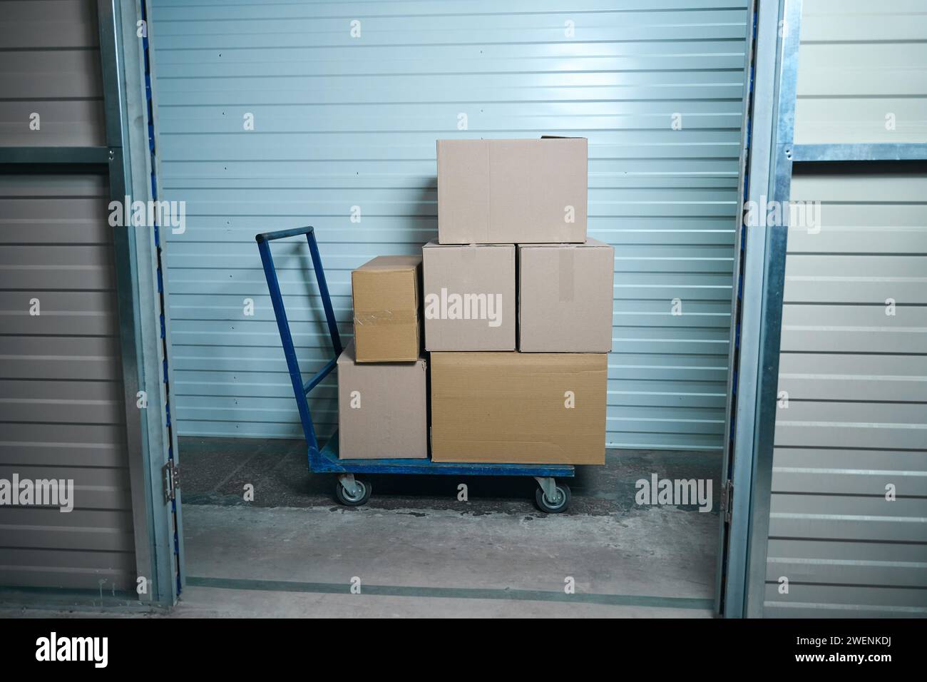 Cardboard boxes on a trolley in a warehouse Stock Photo - Alamy