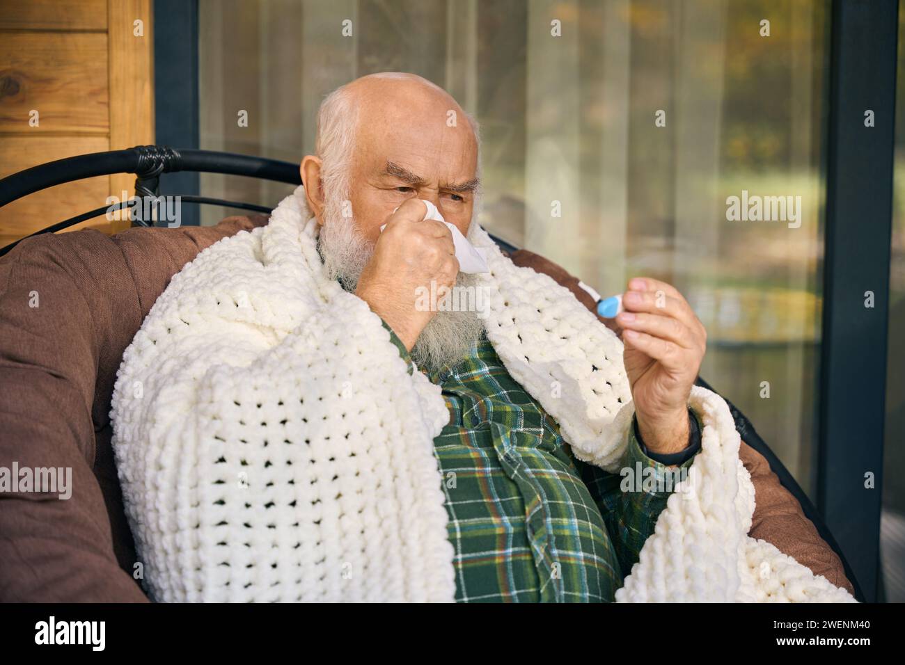 Sick old man is wrapped in fluffy blanket on veranda Stock Photo - Alamy