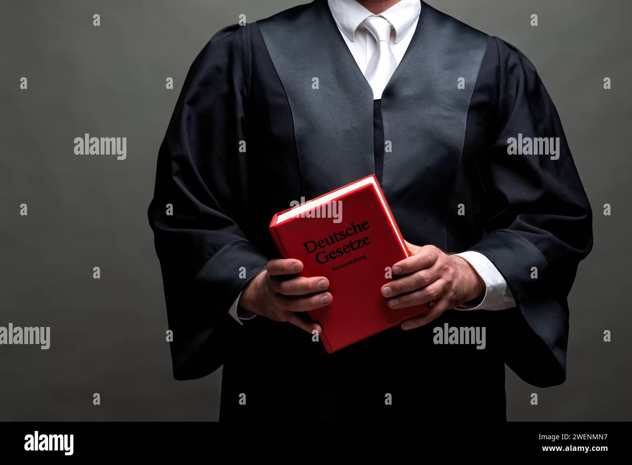 german lawyer with a classical black robe, white tie and book Stock ...