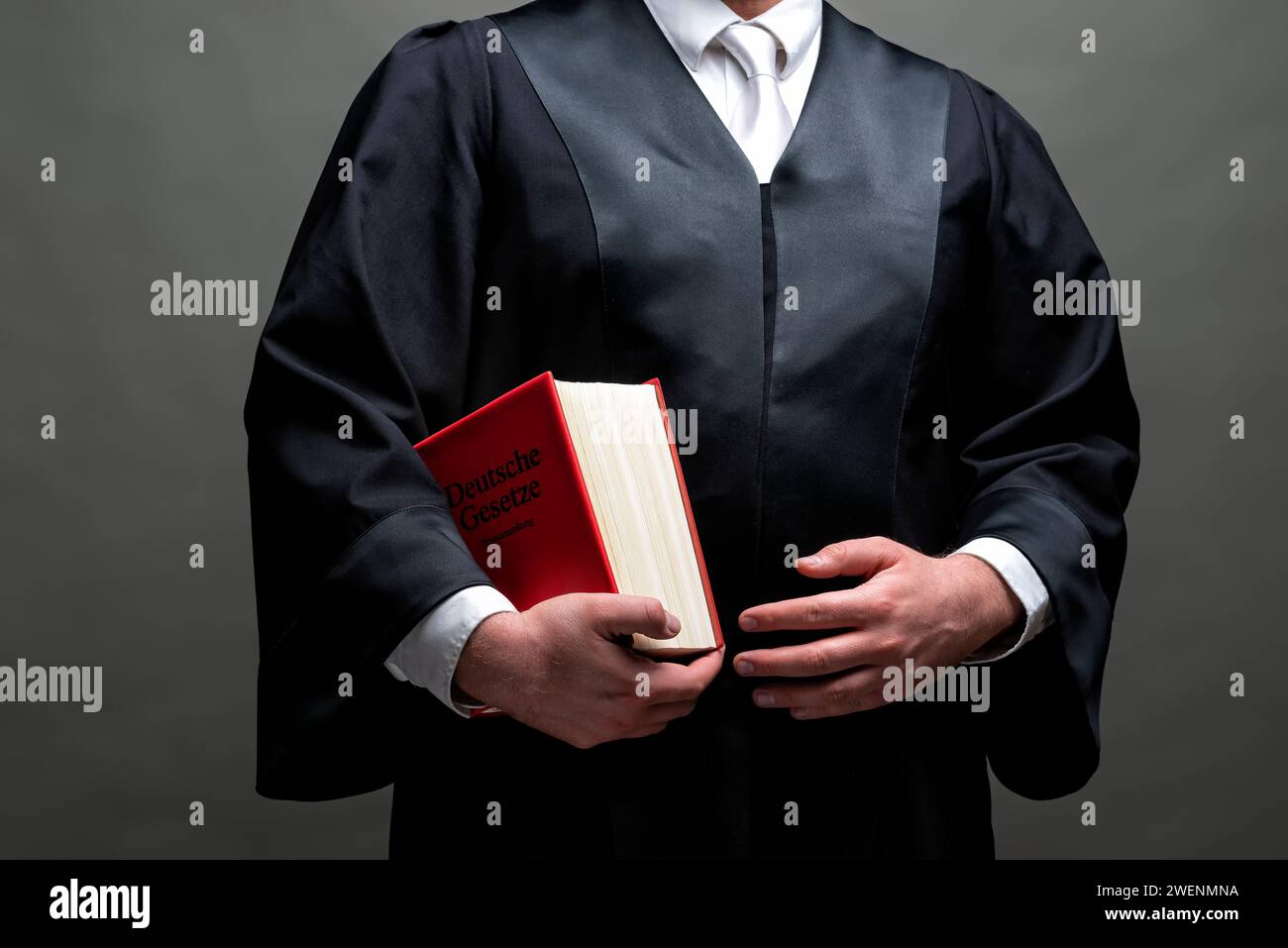 german lawyer with a classical black robe, white tie and book Stock ...