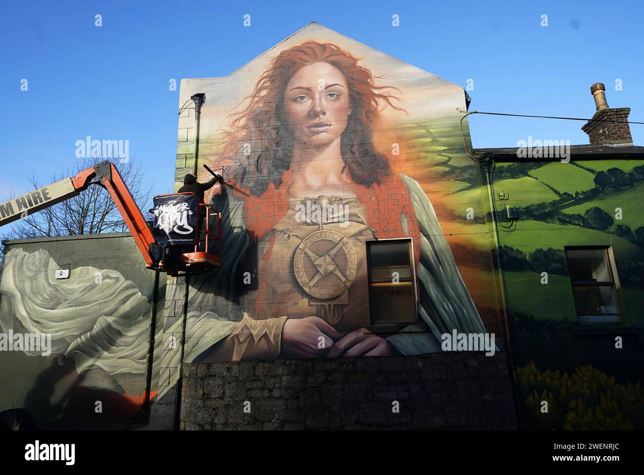 Street artist Mister Copy continues work on a mural depicting St ...