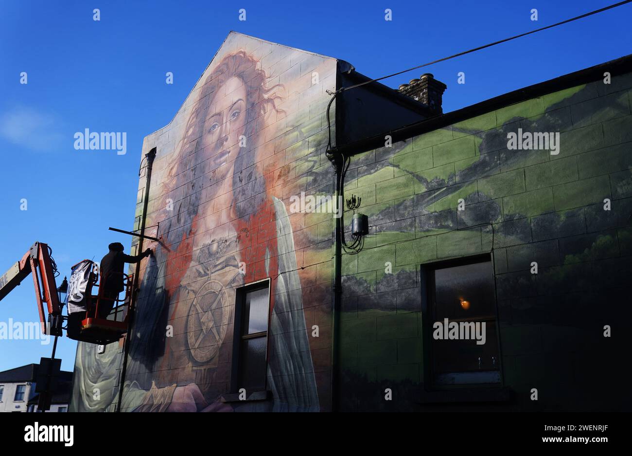 Street artist Mister Copy continues work on a mural depicting St ...