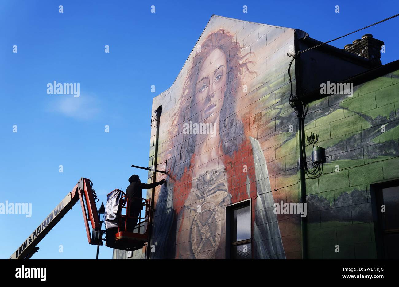 Street artist Mister Copy continues work on a mural depicting St ...