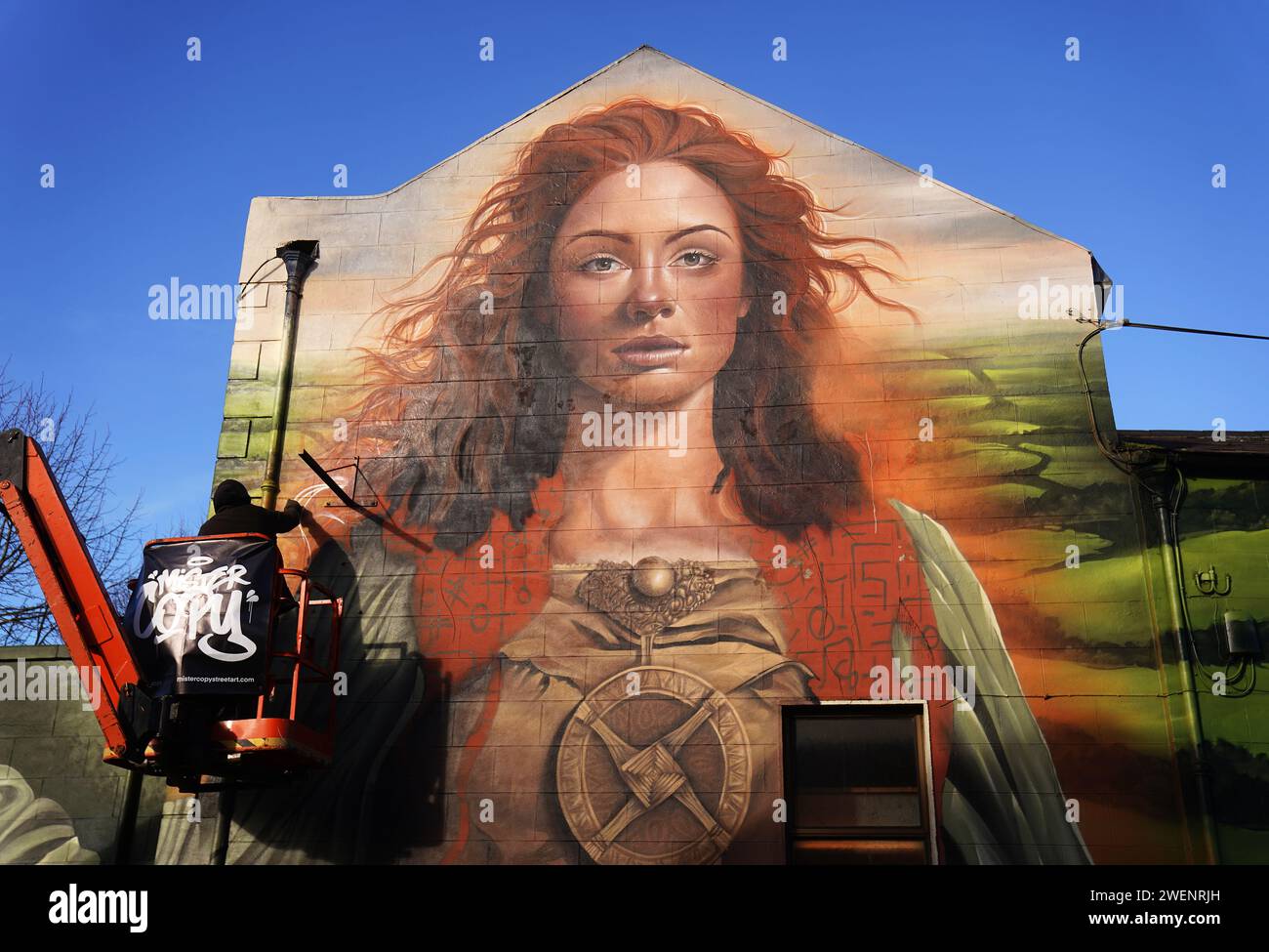 Street artist Mister Copy continues work on a mural depicting St ...
