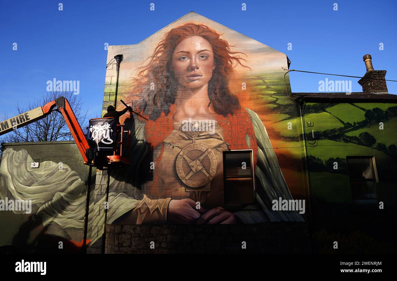 Street artist Mister Copy continues work on a mural depicting St ...