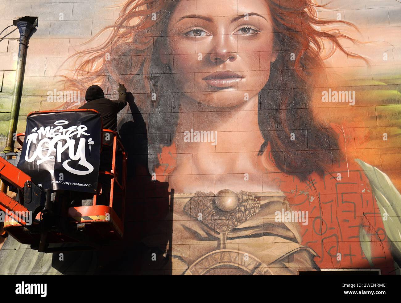 Street artist Mister Copy continues work on a mural depicting St ...