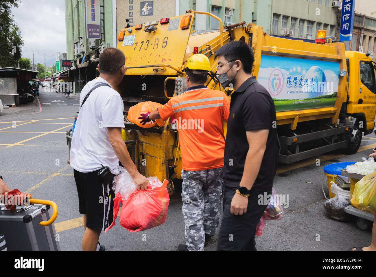 Yilan, Republic of China - October 2, 2023: A garbage truck and binmen ...