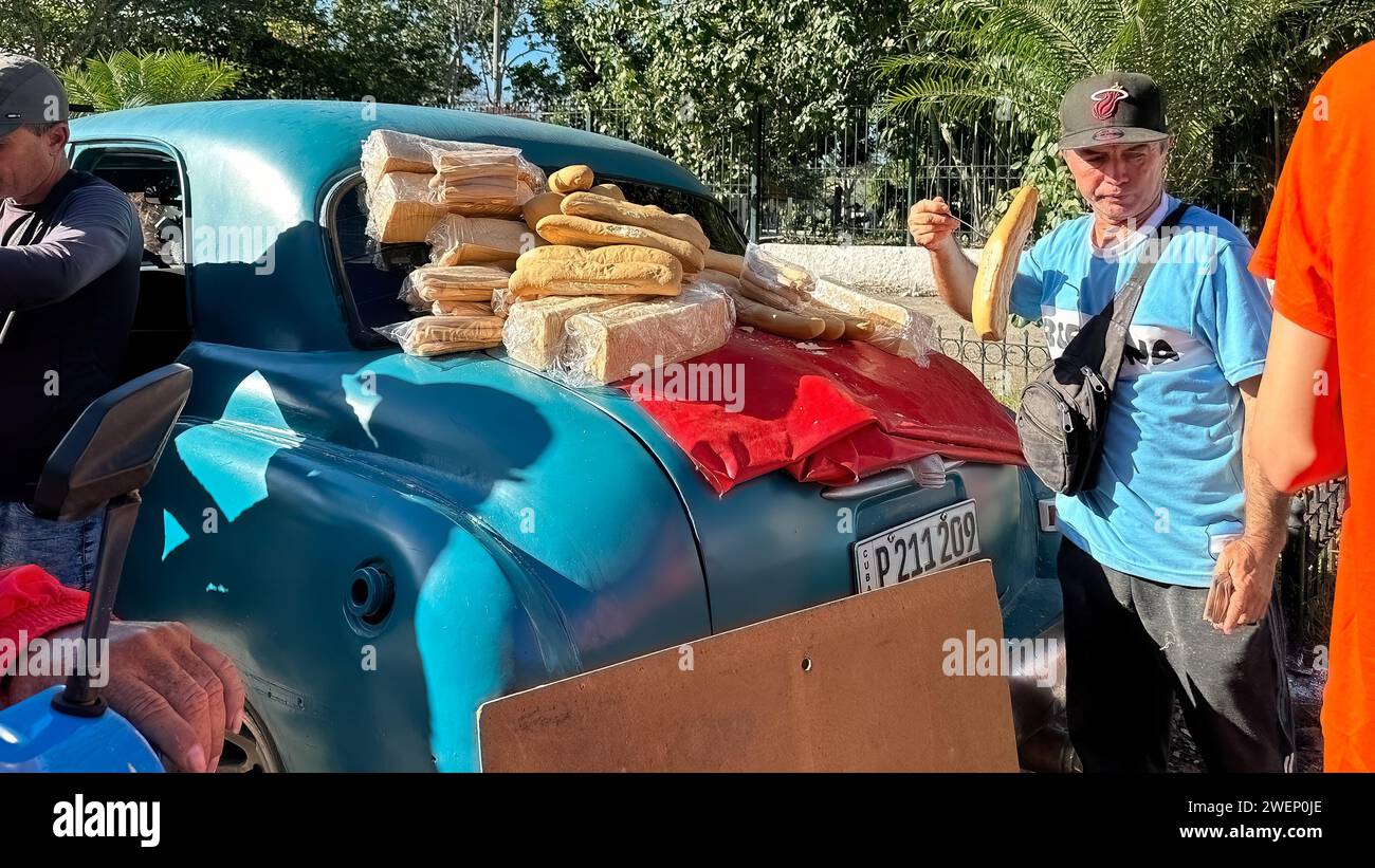 Cuban man selling bread loaves in vintage car in Santa Clara, Cuba ...