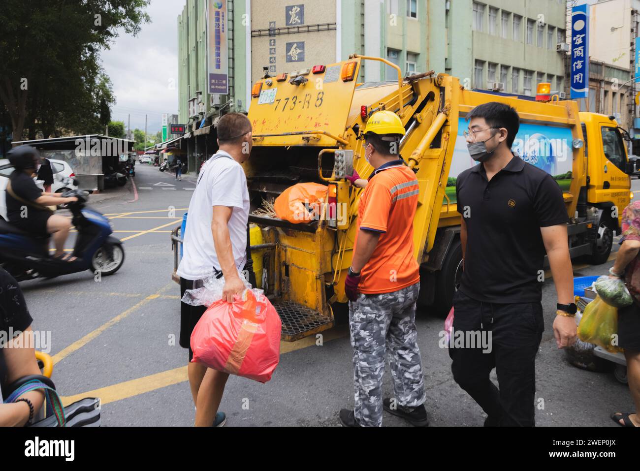 Yilan, Republic of China - October 2, 2023: A garbage truck and binmen ...