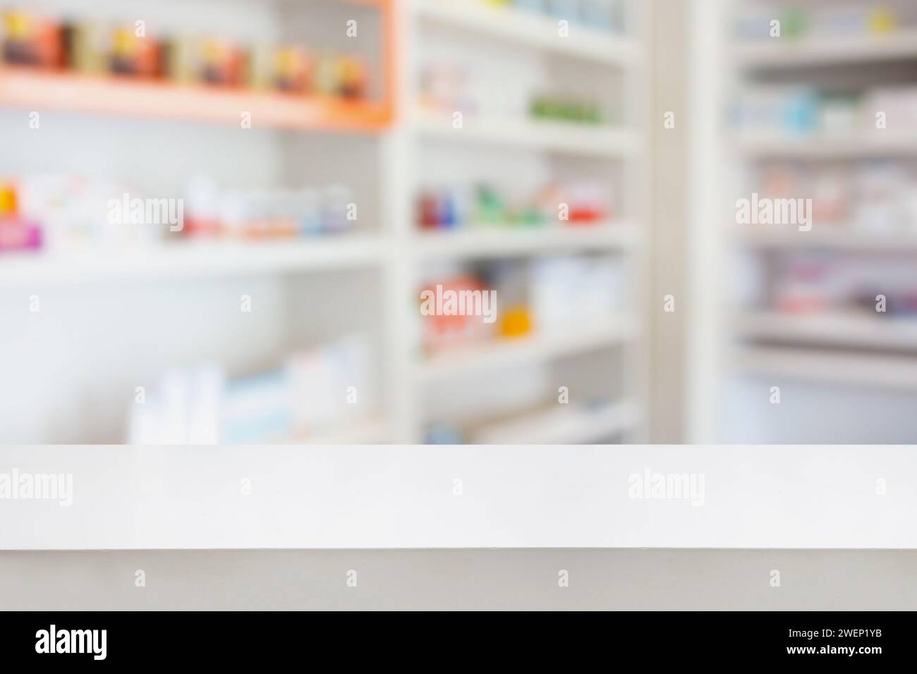 Blank white pharmacy table counter with blur shelves of drug in the ...