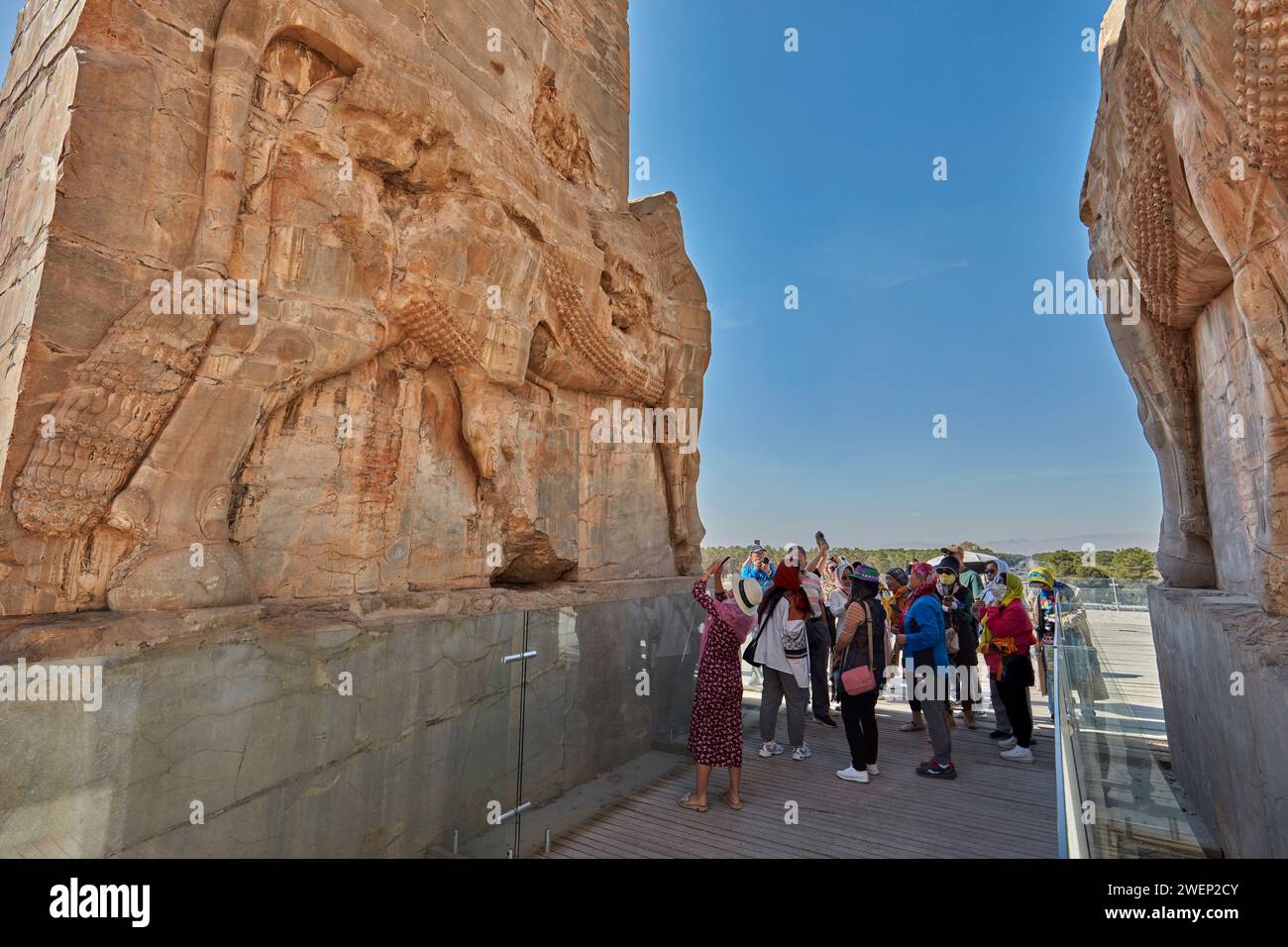 A group of tourists at the Gate of All Nations in Persepolis, an ...
