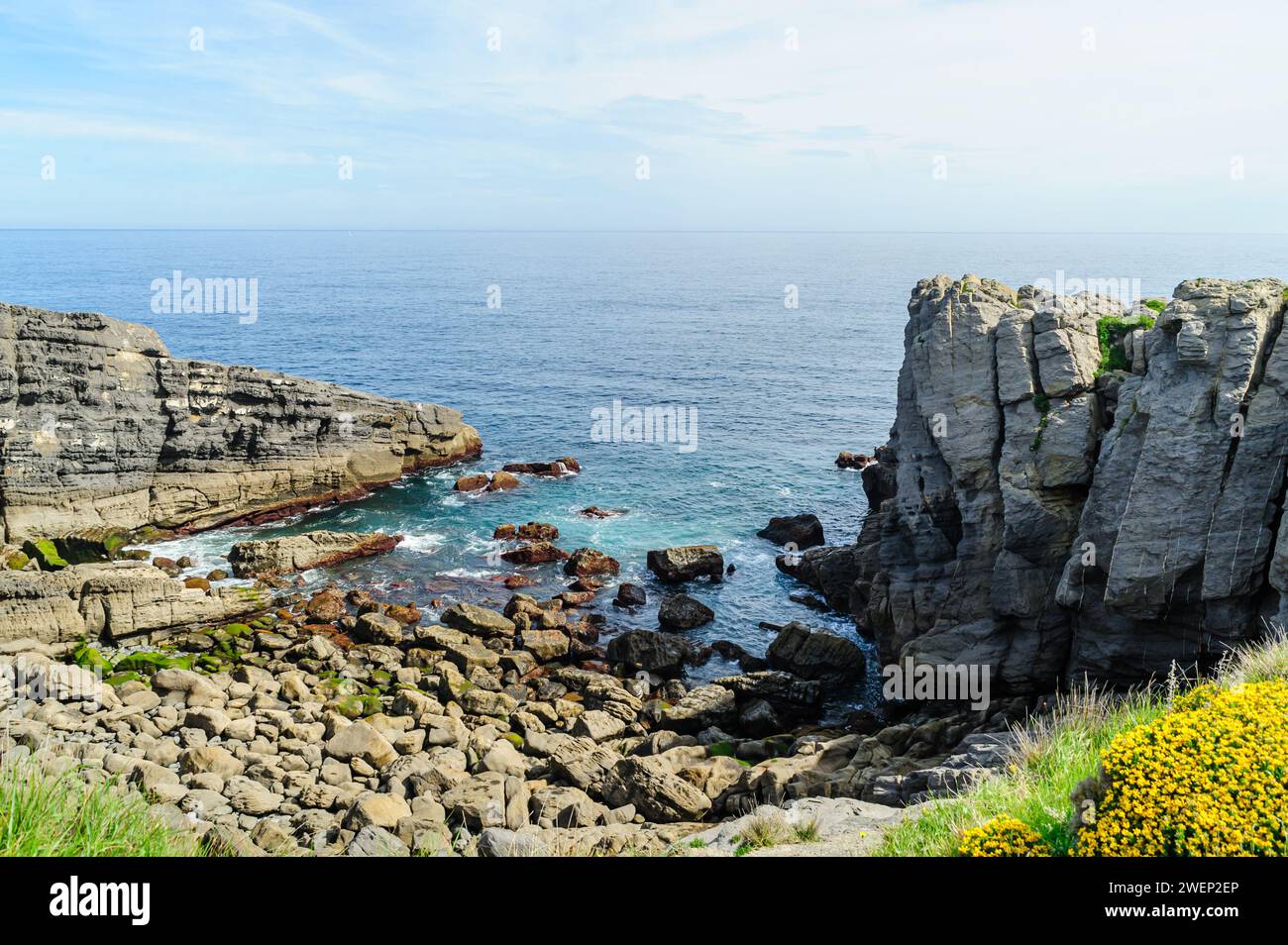 Striking layered rock formations along the rugged coast of Northern ...