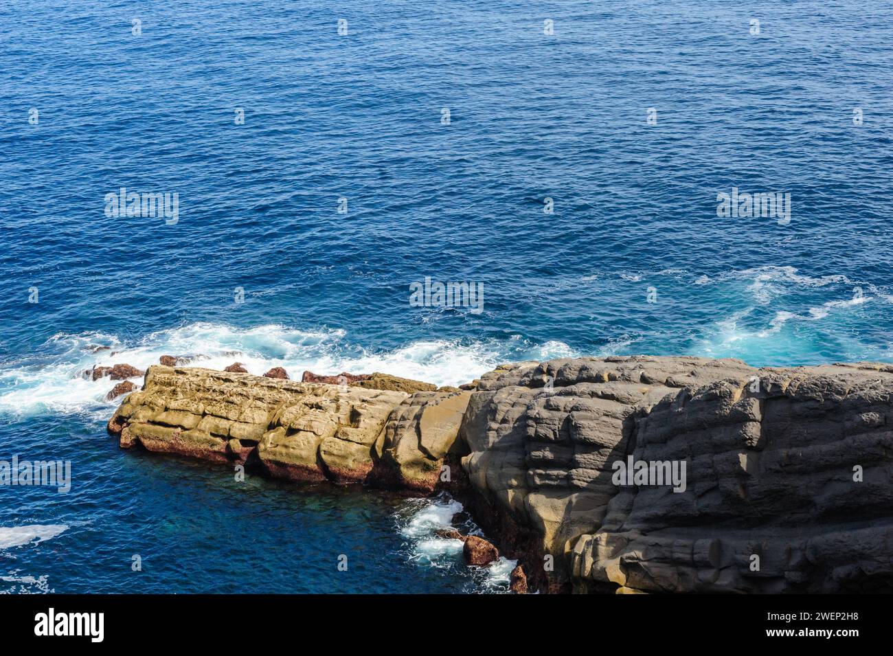 Striking layered rock formations along the rugged coast of Northern ...