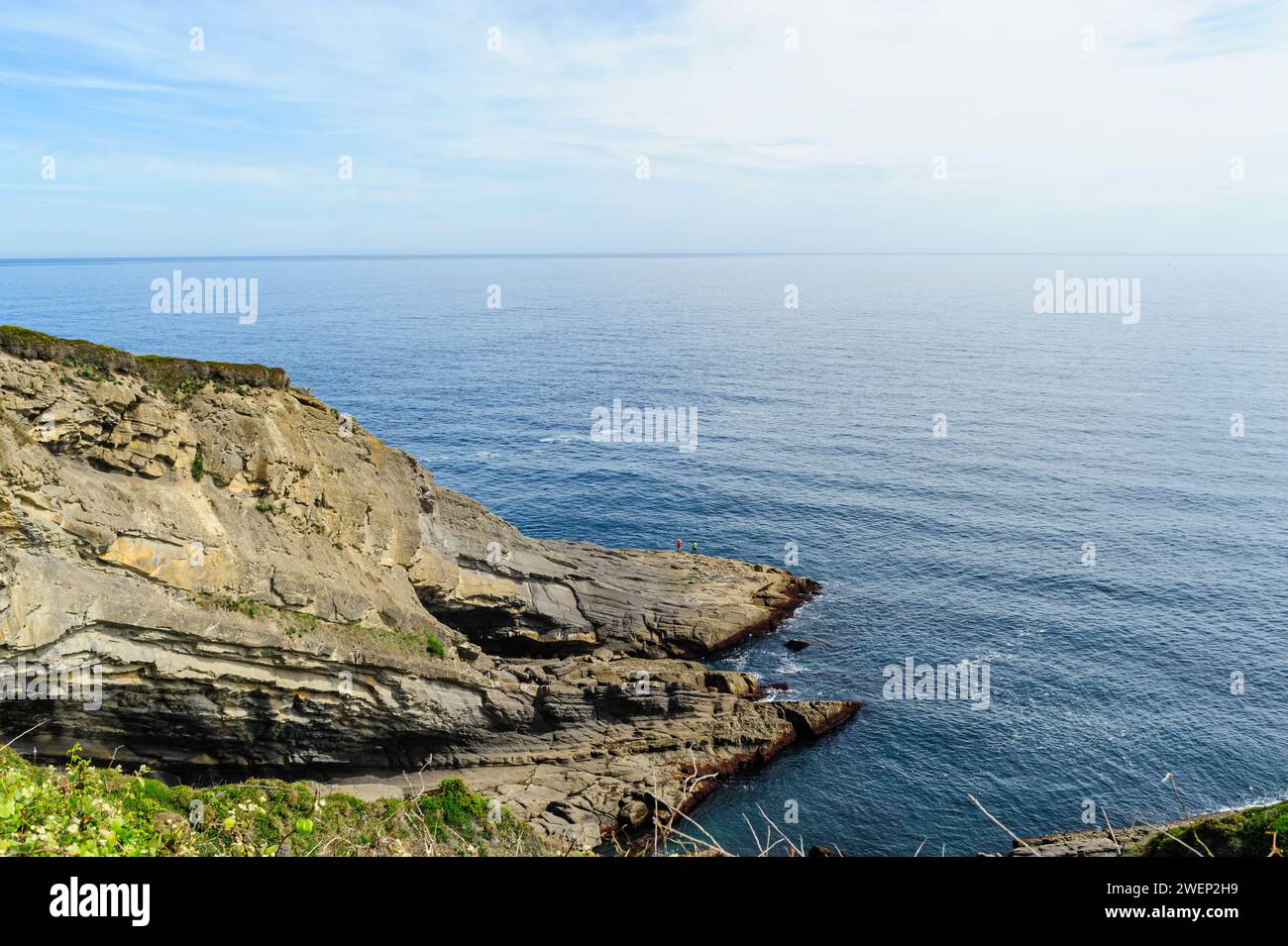 Striking layered rock formations along the rugged coast of Northern ...