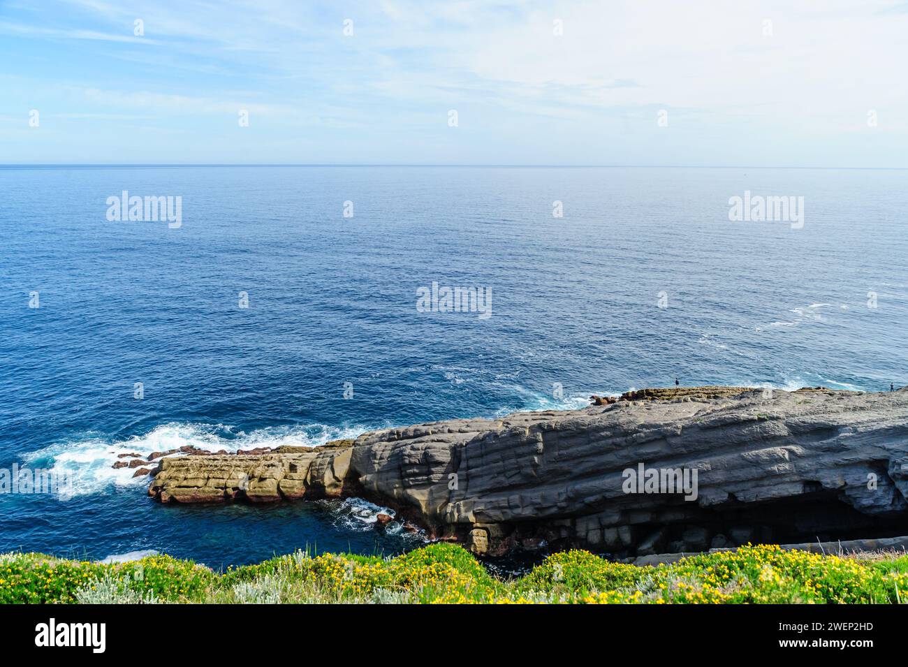 Striking layered rock formations along the rugged coast of Northern ...