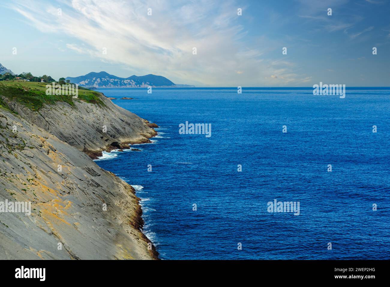 Striking layered rock formations along the rugged coast of Northern ...