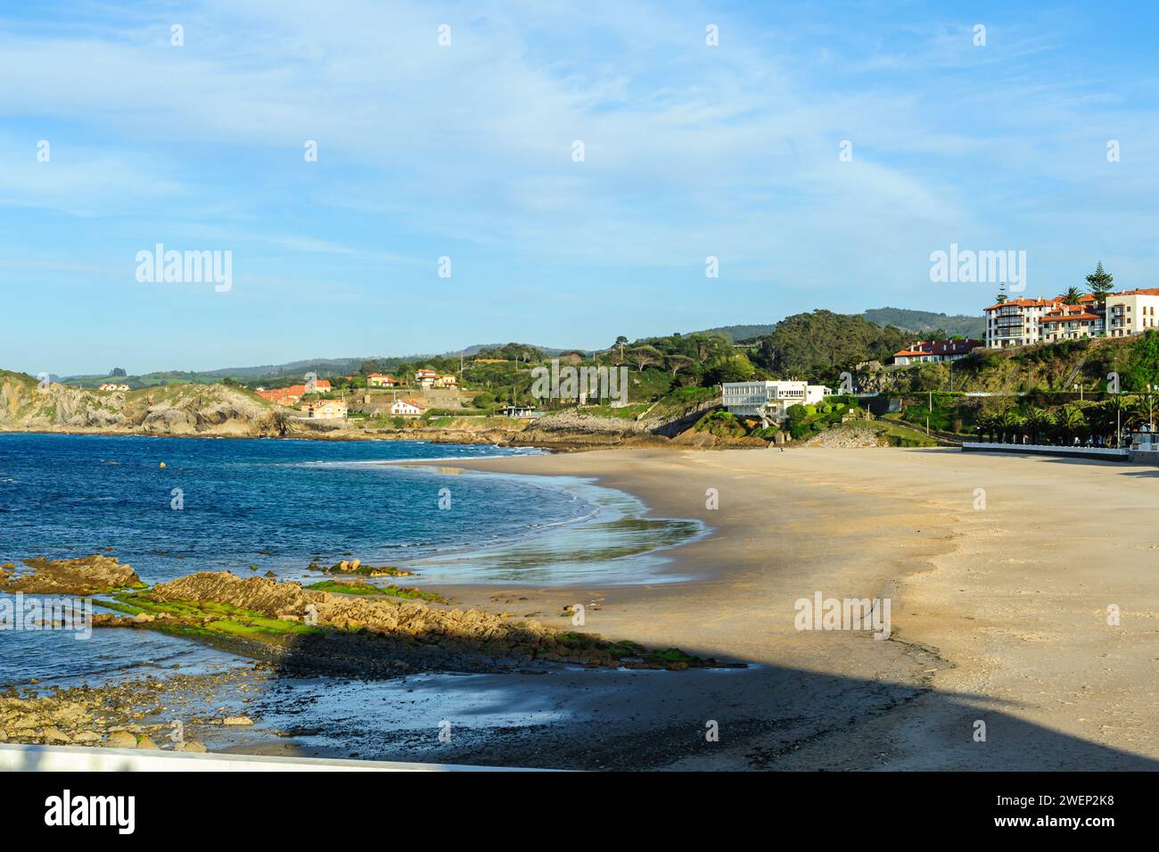 Golden sands and calm blue waters of the beach in Comillas, with a ...