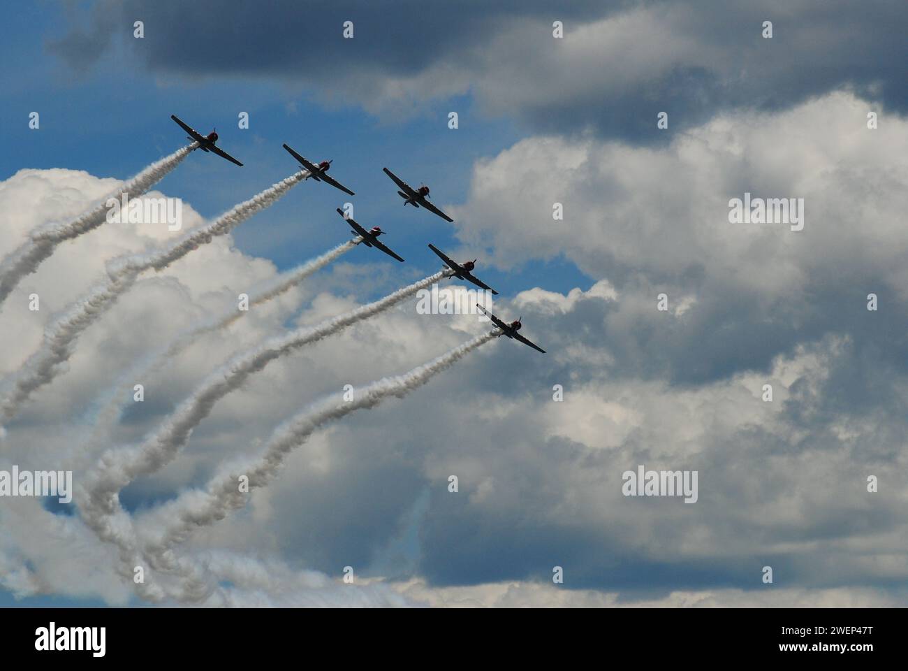 A skywriting team makes a maneuver, turning from descent to a climb in ...