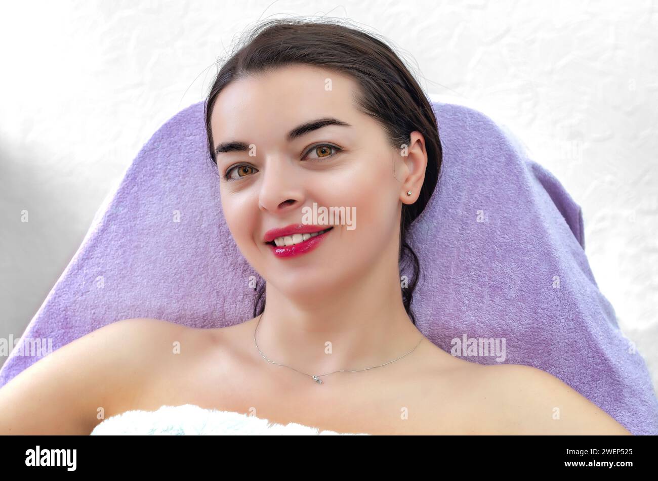 Beautiful woman lying on couch in spa salon Woman smiling in beauty ...