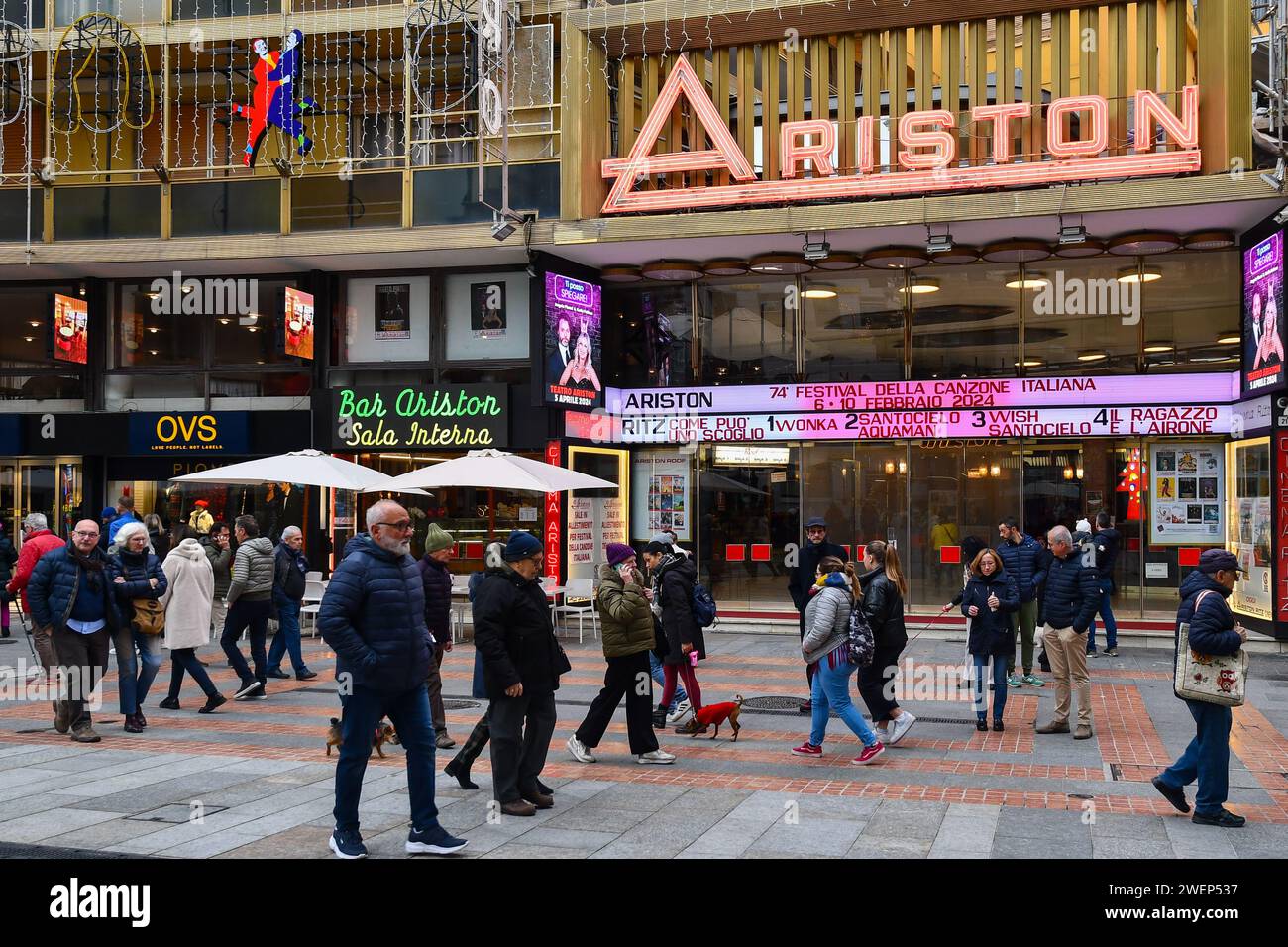 People walking in front of the Ariston Theatre, famous for annually ...
