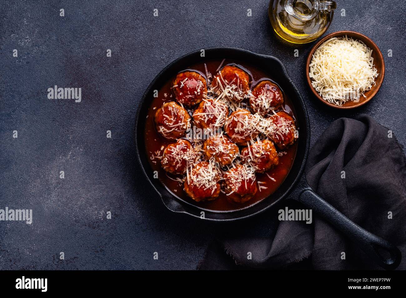Beef meatballs with barbecue tomato sauce and parmesan cheese in cast ...