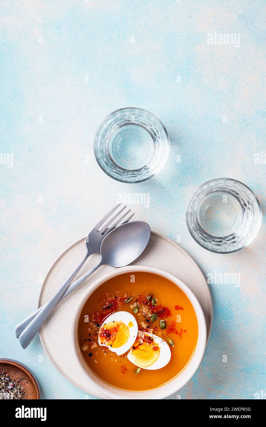 Butternut squash and carrot soup with boiled egg, autumn or winter creamy delicious healthy food ...