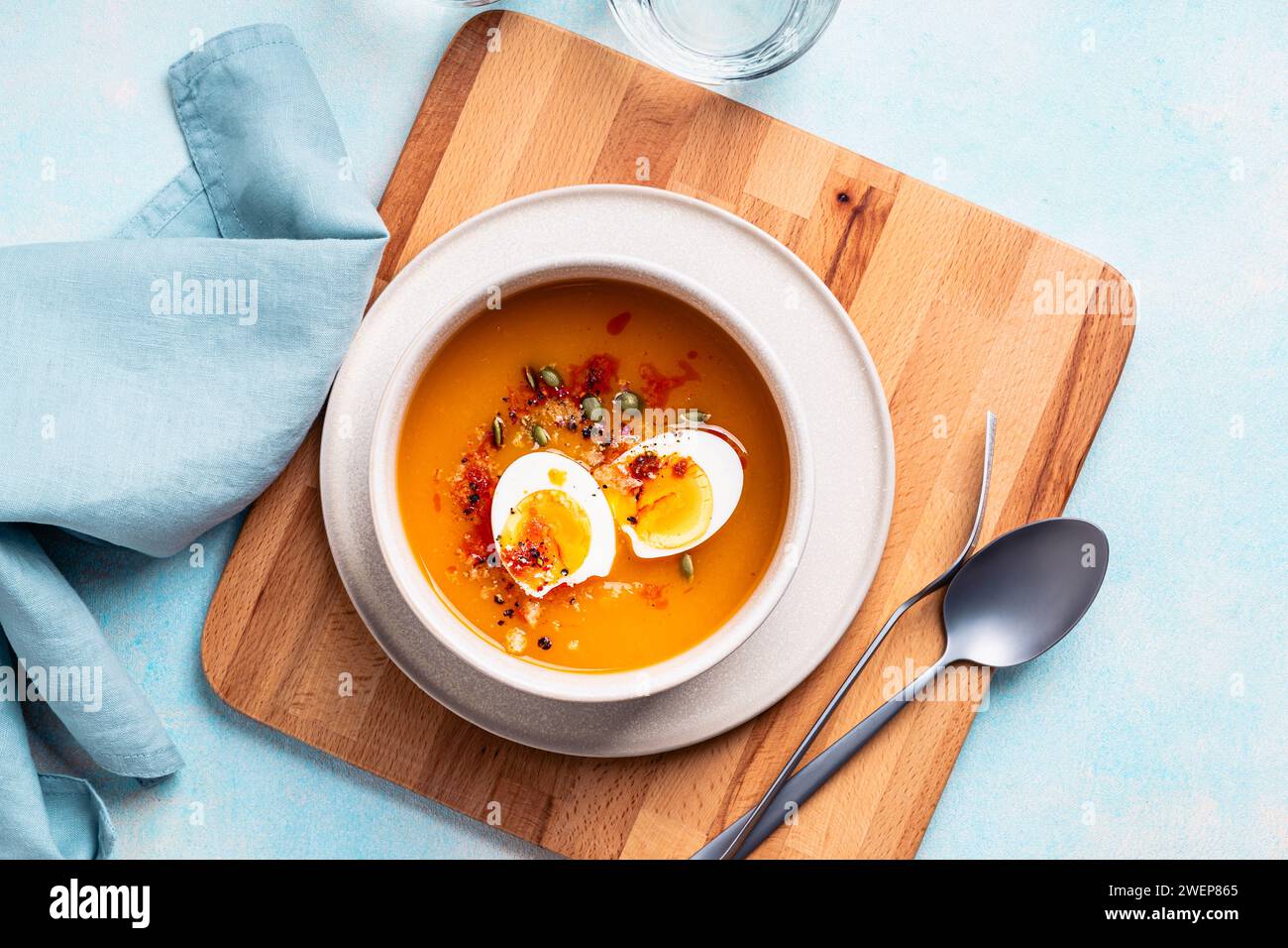 Butternut squash and carrot soup with boiled egg, autumn or winter creamy delicious healthy food ...