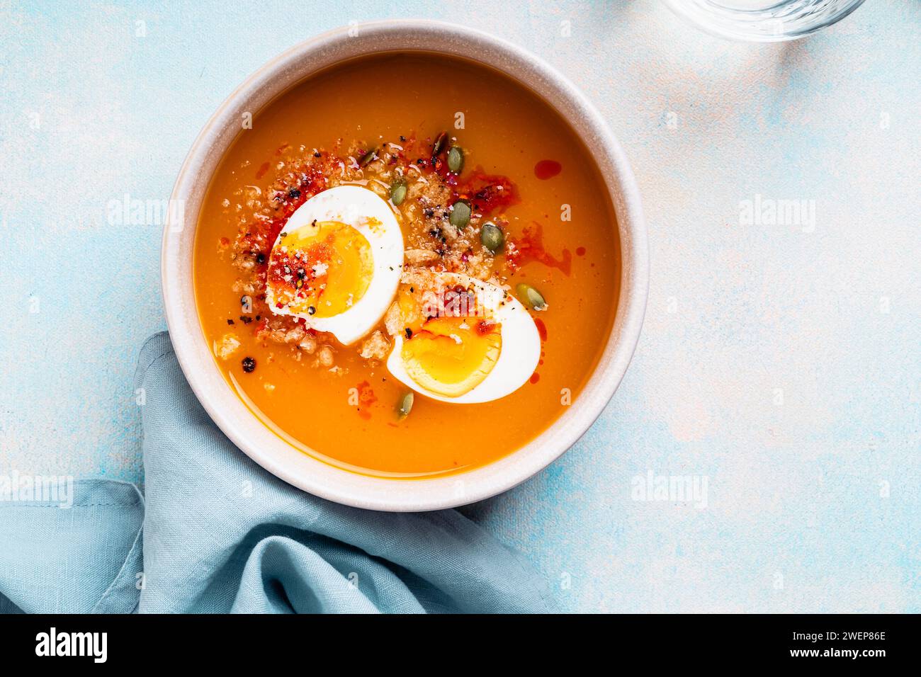 Butternut squash and carrot soup with boiled egg, autumn or winter creamy delicious healthy food ...