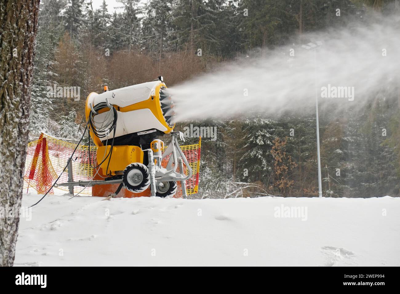 Snow cannon makes artificial snow. Snowmaking systems sprays water to ...