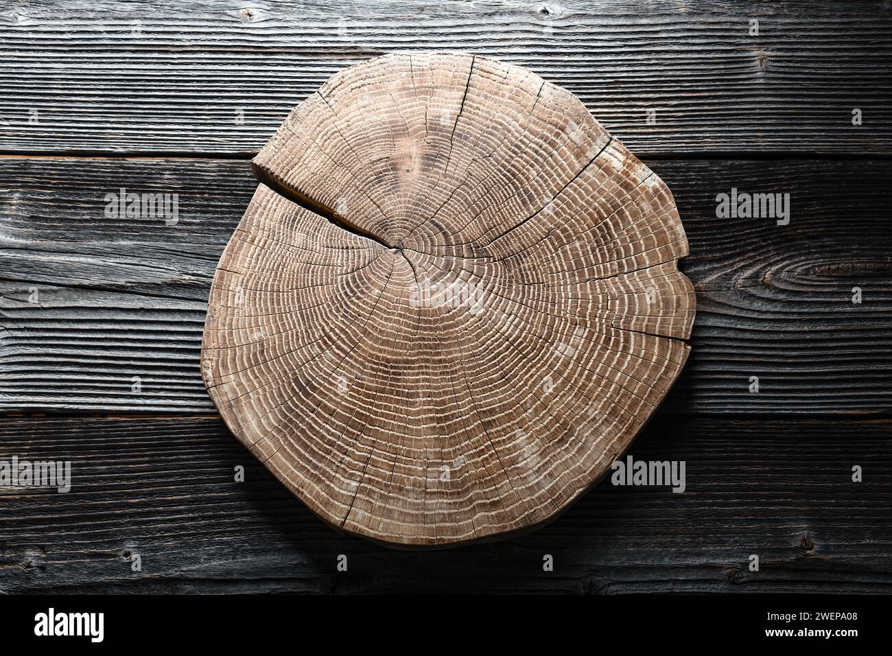 Wooden plate carved from tree trunk on old grunge wooden table. Can be ...