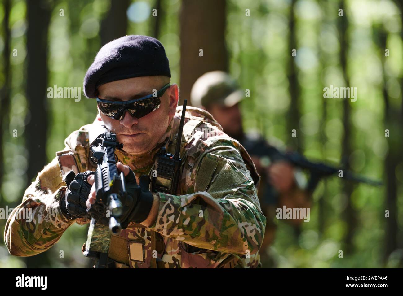 An elite soldier, camouflaged and stealthily navigating through ...