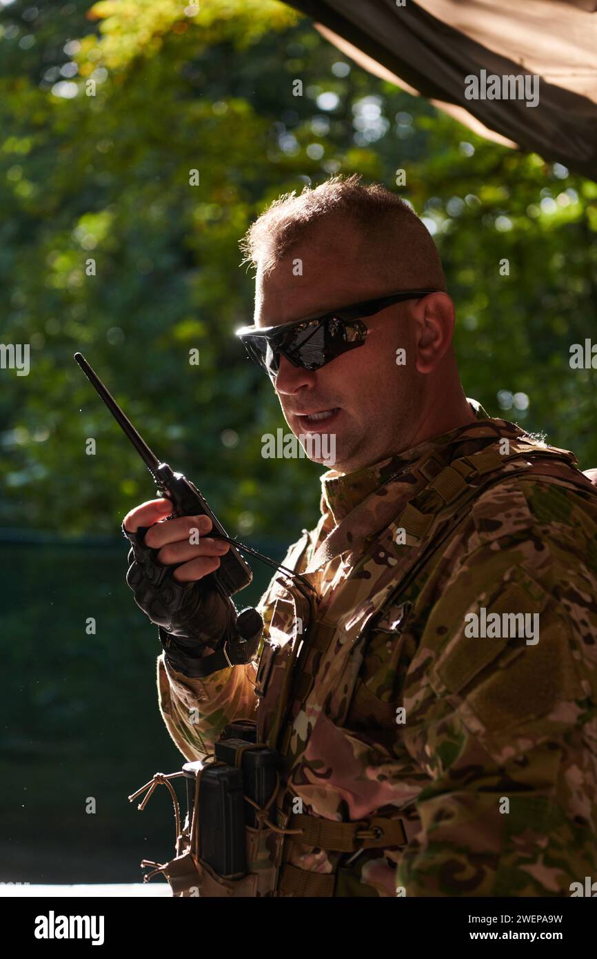 A military major employs a Motorola radio for seamless communication ...