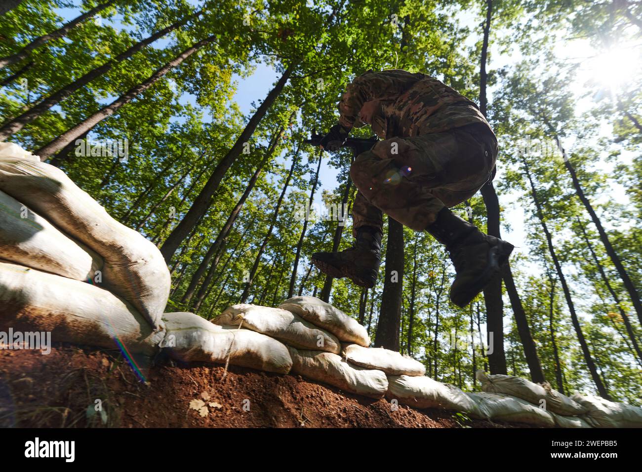 An elite soldier adeptly clears military barriers in the perilous ...