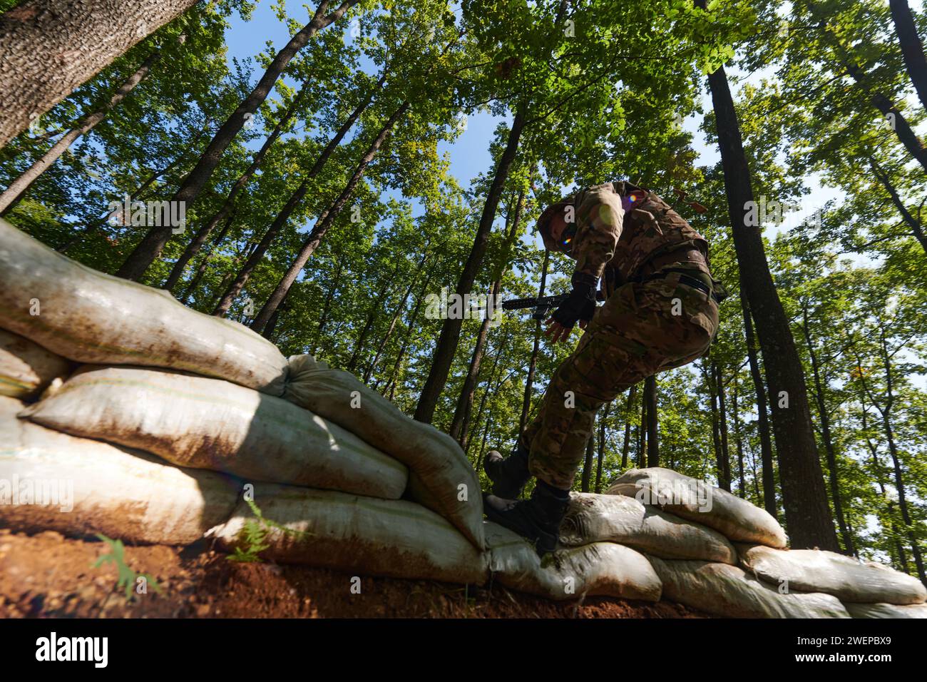 An elite soldier adeptly clears military barriers in the perilous ...