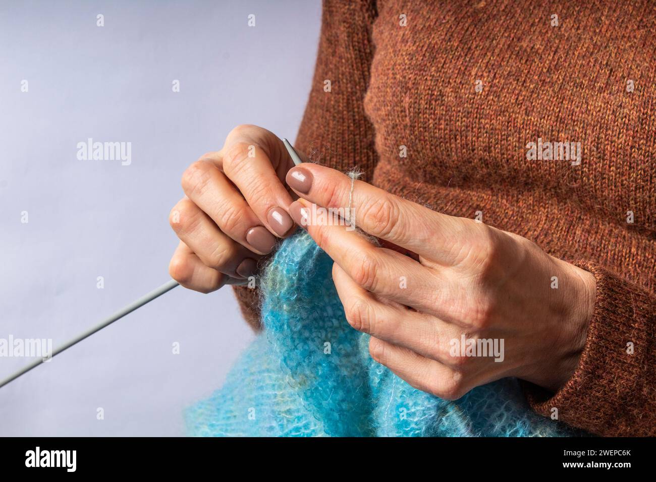 Close-up of hands knitting. Process of knitting. Hand made Stock Photo ...