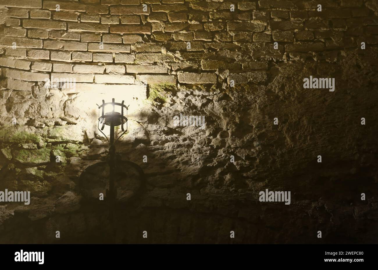 Lighted medieval castle torch hanging on a stone wall, vintage objects ...