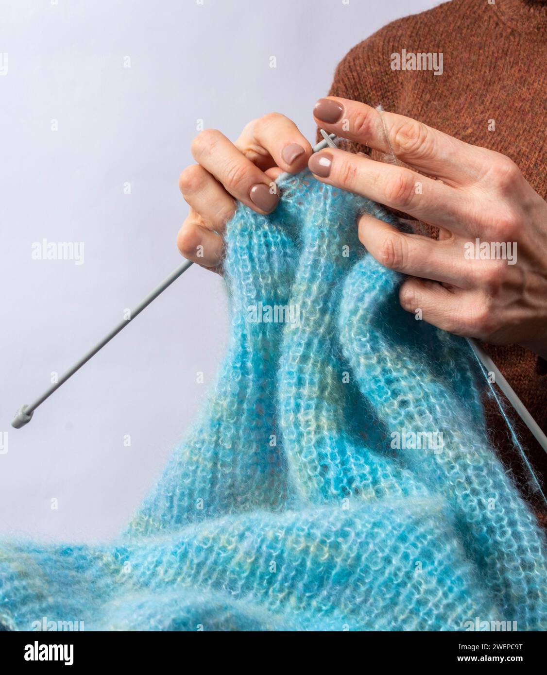 Close-up of hands knitting. Process of knitting. Hand made Stock Photo ...